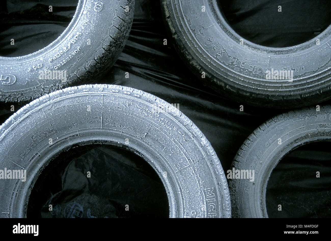 Old heap of tires , tyres outside with frost on them Stock Photo - Alamy