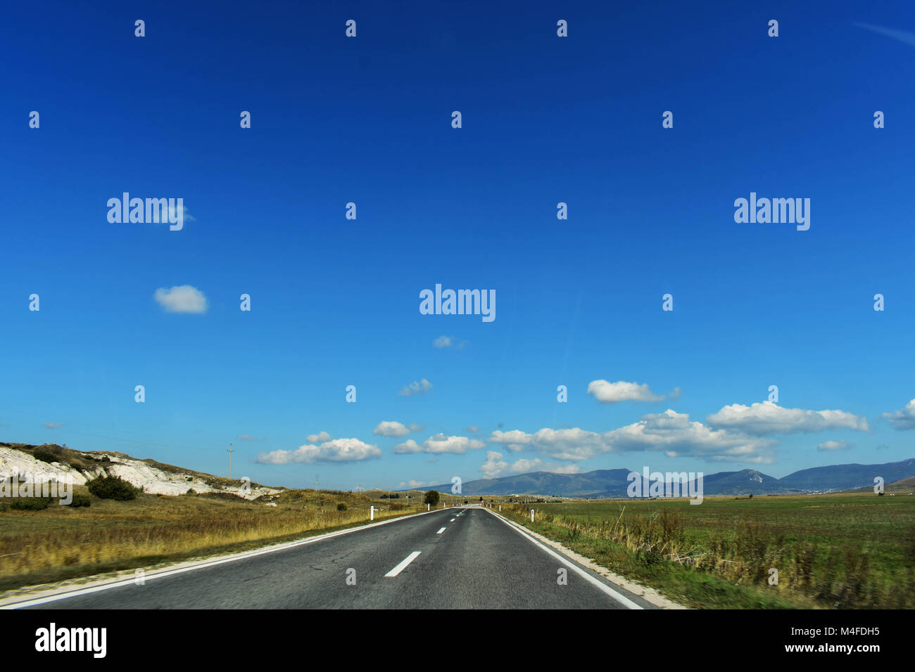Driving on empty road through beautiful countryside view Stock Photo ...