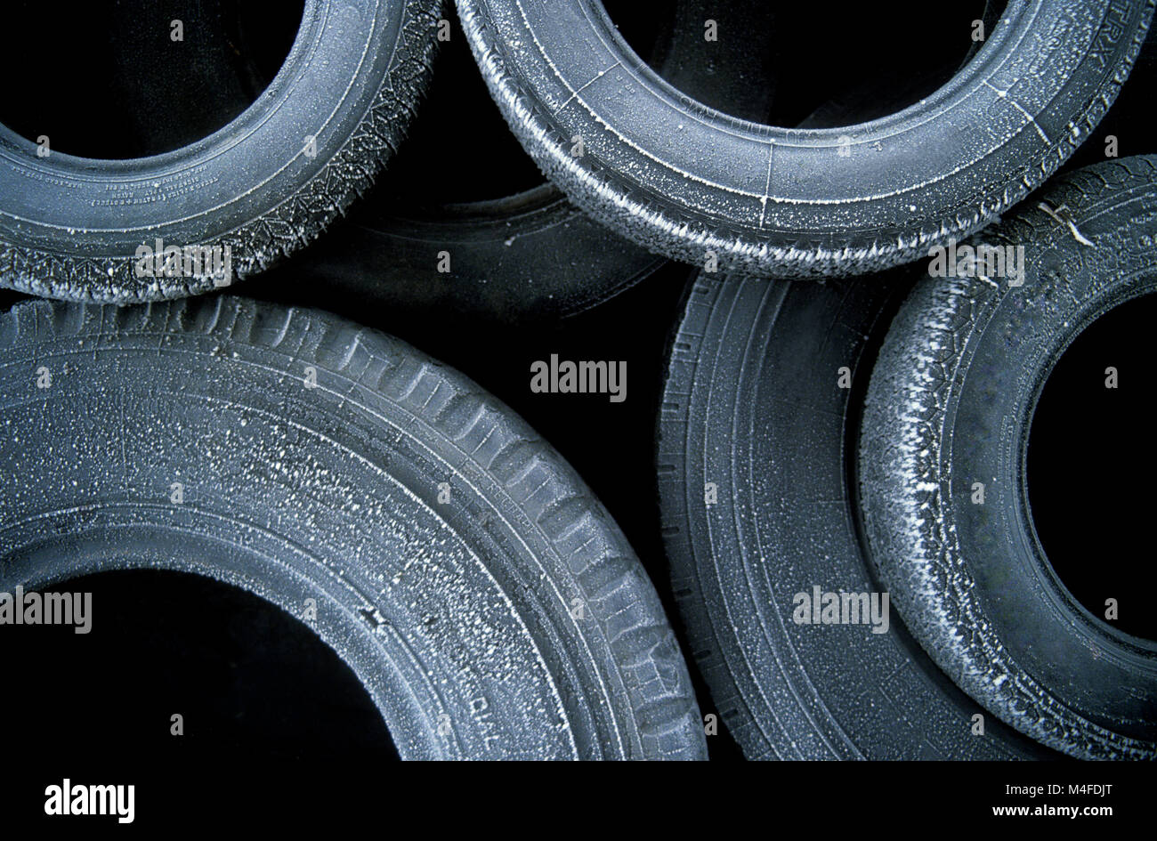 Old heap of tires , tyres outside with frost on them Stock Photo - Alamy