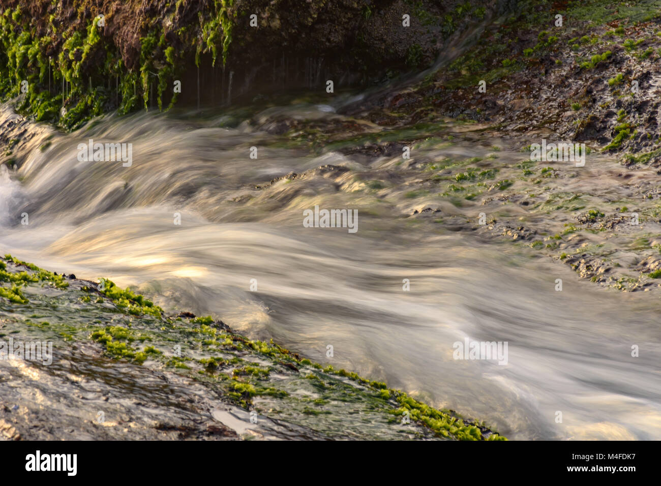 Sea water between the stones Stock Photo - Alamy