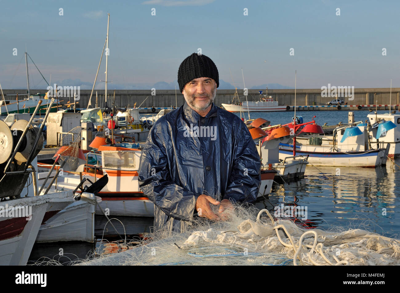 fisherman working in the fishing port Stock Photo - Alamy