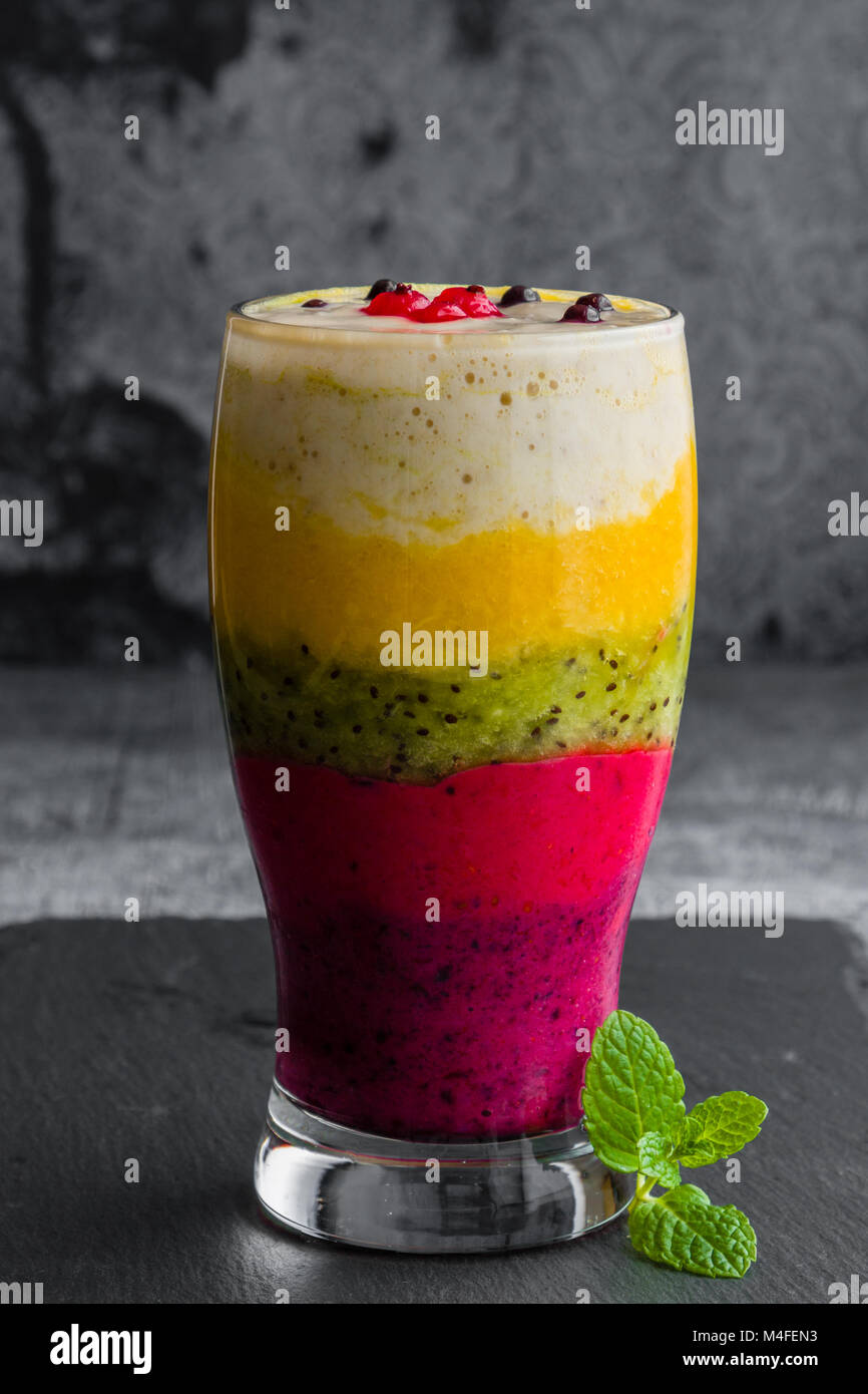 colorful smoothie made of different fruits layered in a glass Stock ...