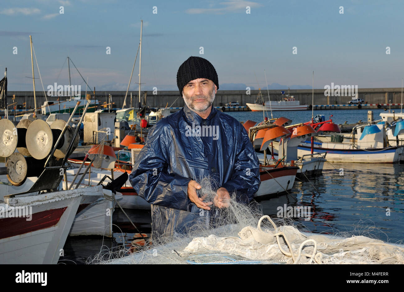 fisherman working in the fishing port Stock Photo - Alamy