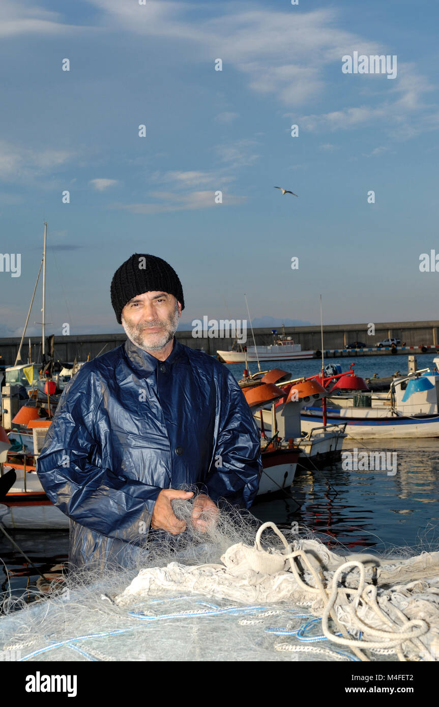 fisherman working in the fishing port Stock Photo - Alamy