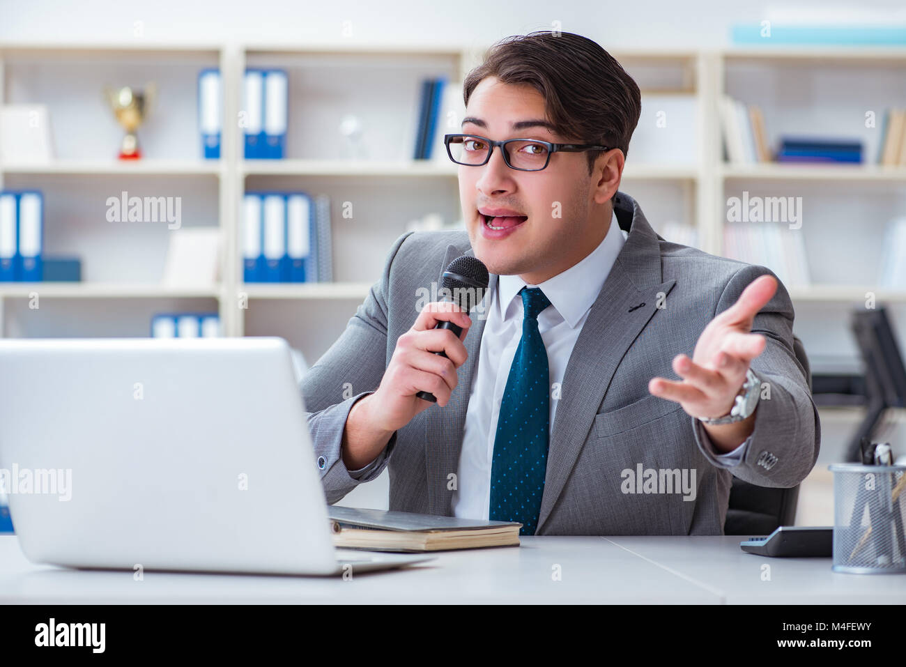 Businessman singing in the office Stock Photo - Alamy