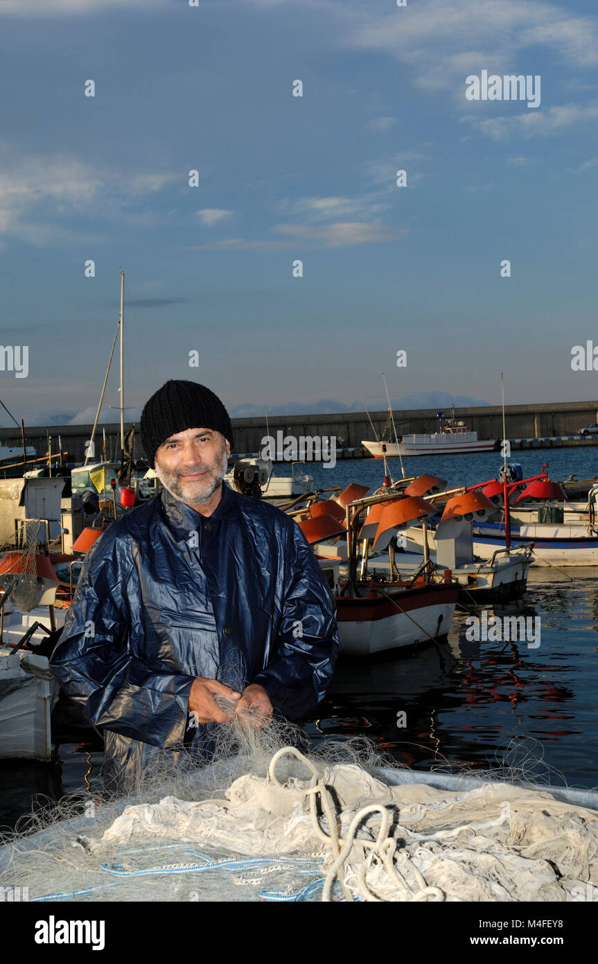 fisherman working in the fishing port Stock Photo - Alamy