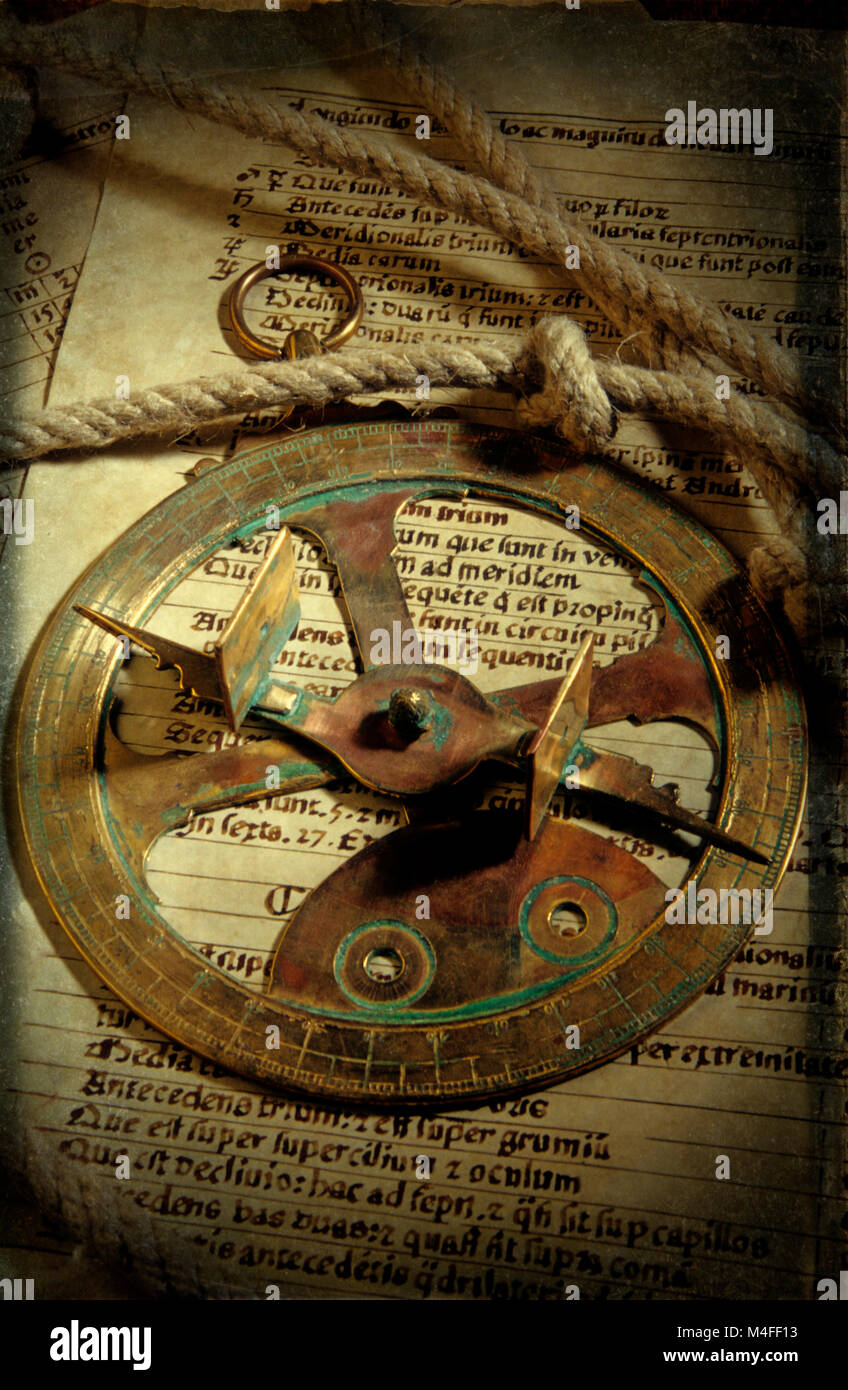 Navigational instrument resting on a table covered with nautical charts ...