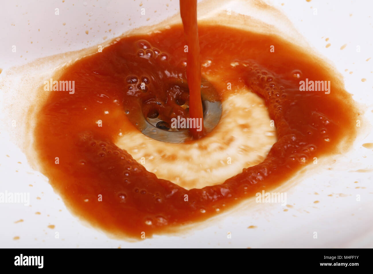 Close up dirty rusty brown polluted water flowing from tap in bathroom ...