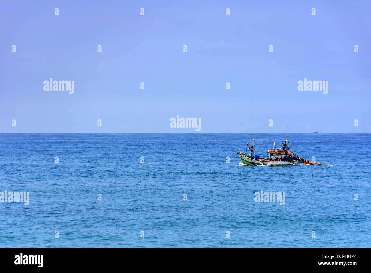 Fishing boat sailing Stock Photo - Alamy