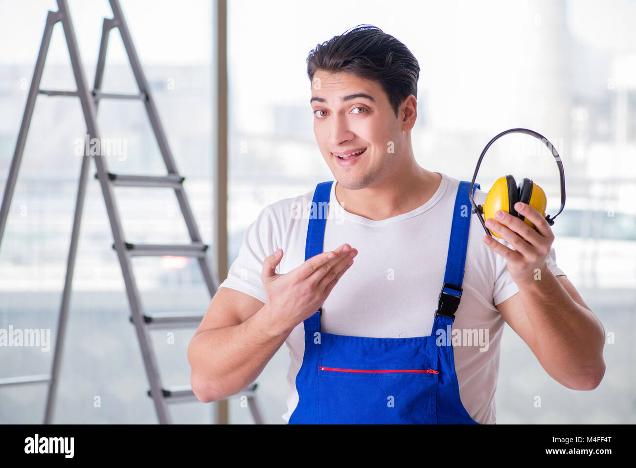 Worker with noise cancelling headphones Stock Photo - Alamy