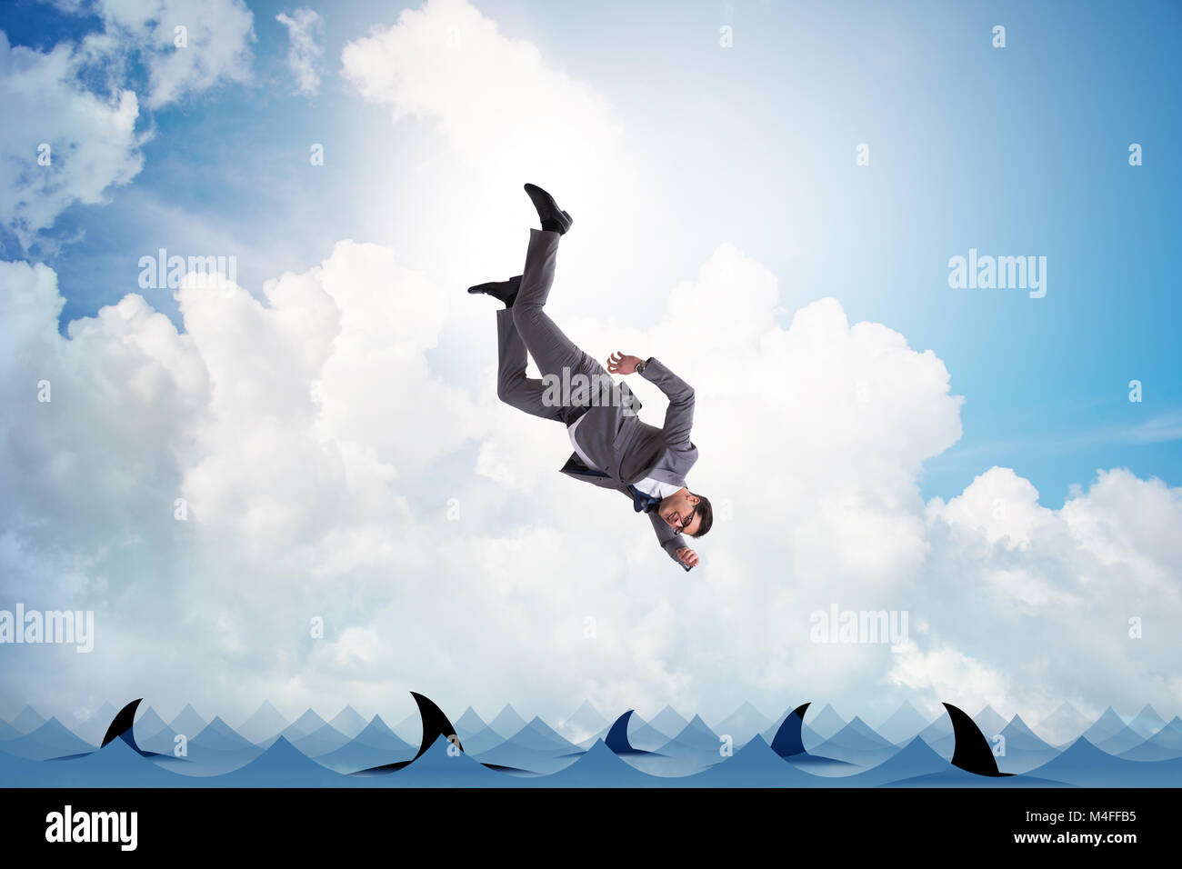 Businessman falling into sea with sharks Stock Photo - Alamy