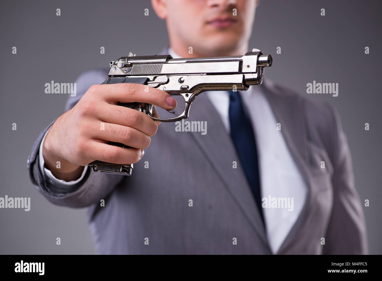 Businessman pulling the gun out of pocket Stock Photo - Alamy