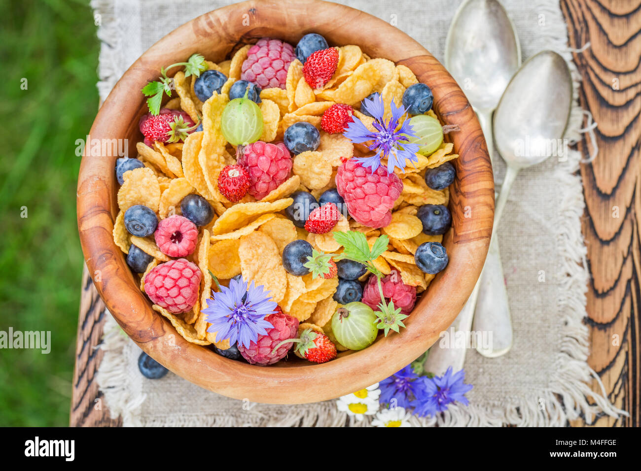 Cornflakes with berry fruits served in garden Stock Photo - Alamy