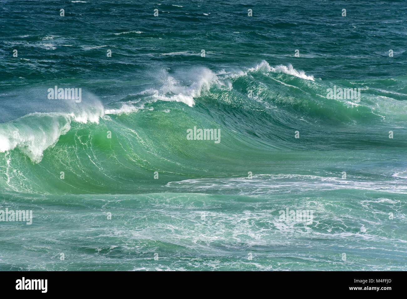 Wave crashing on beach Stock Photo - Alamy