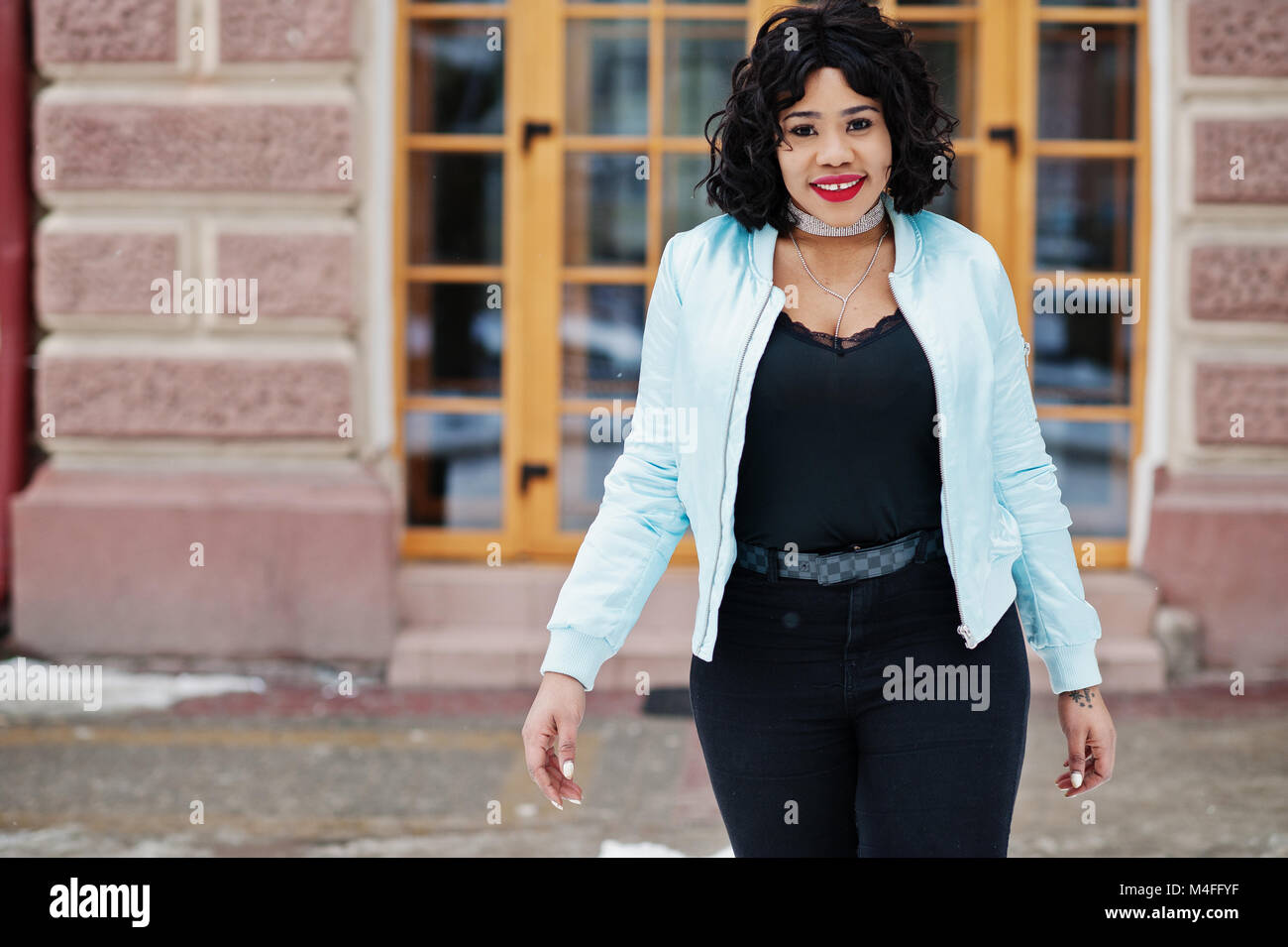 Stylish african american plus size model at streets of city on winter ...