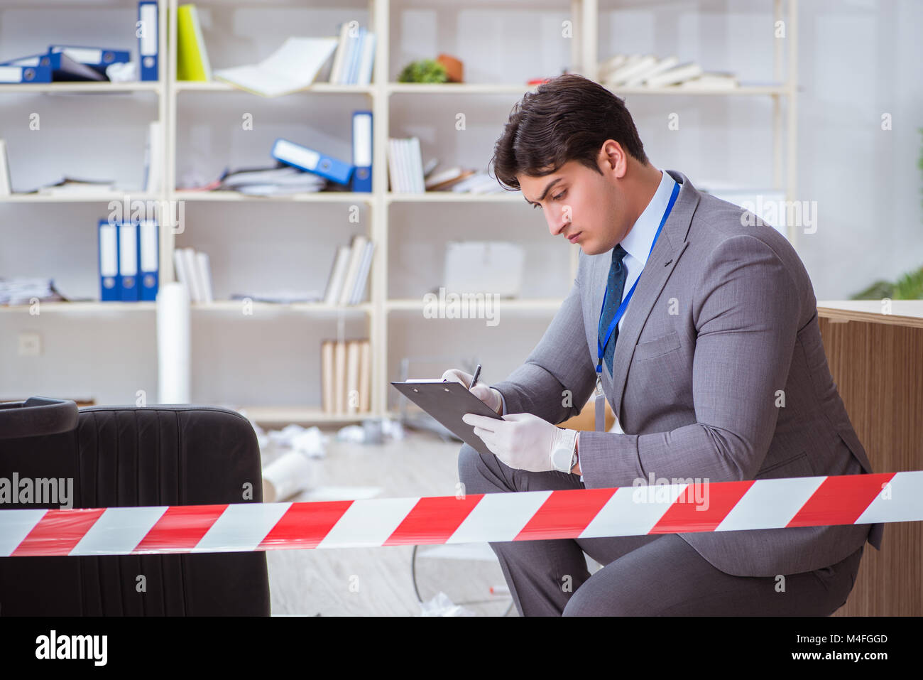 Young man during crime investigation in office Stock Photo - Alamy