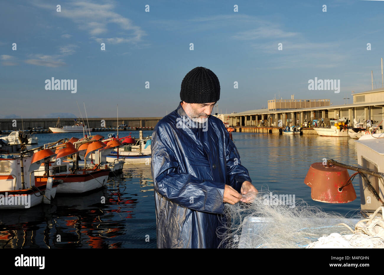 fisherman working in the fishing port Stock Photo - Alamy