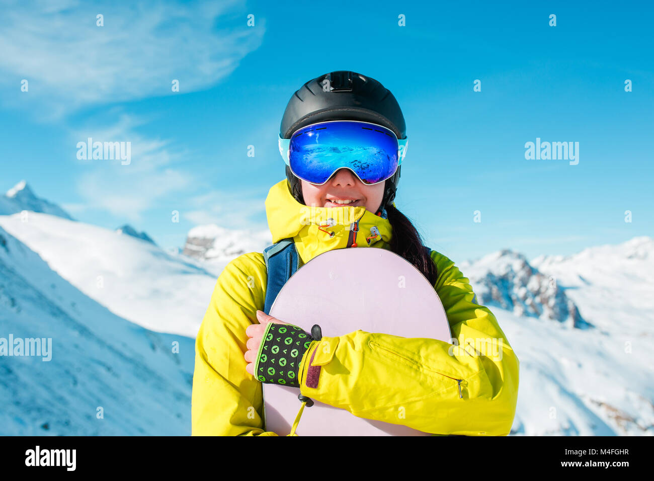 Photo of sporty woman wearing helmet and snowboarding against ...
