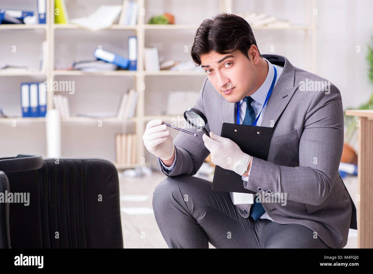 Young man during crime investigation in office Stock Photo - Alamy