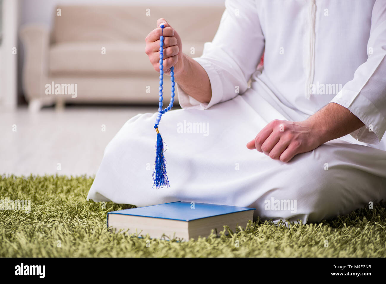 Arab man praying at home Stock Photo - Alamy
