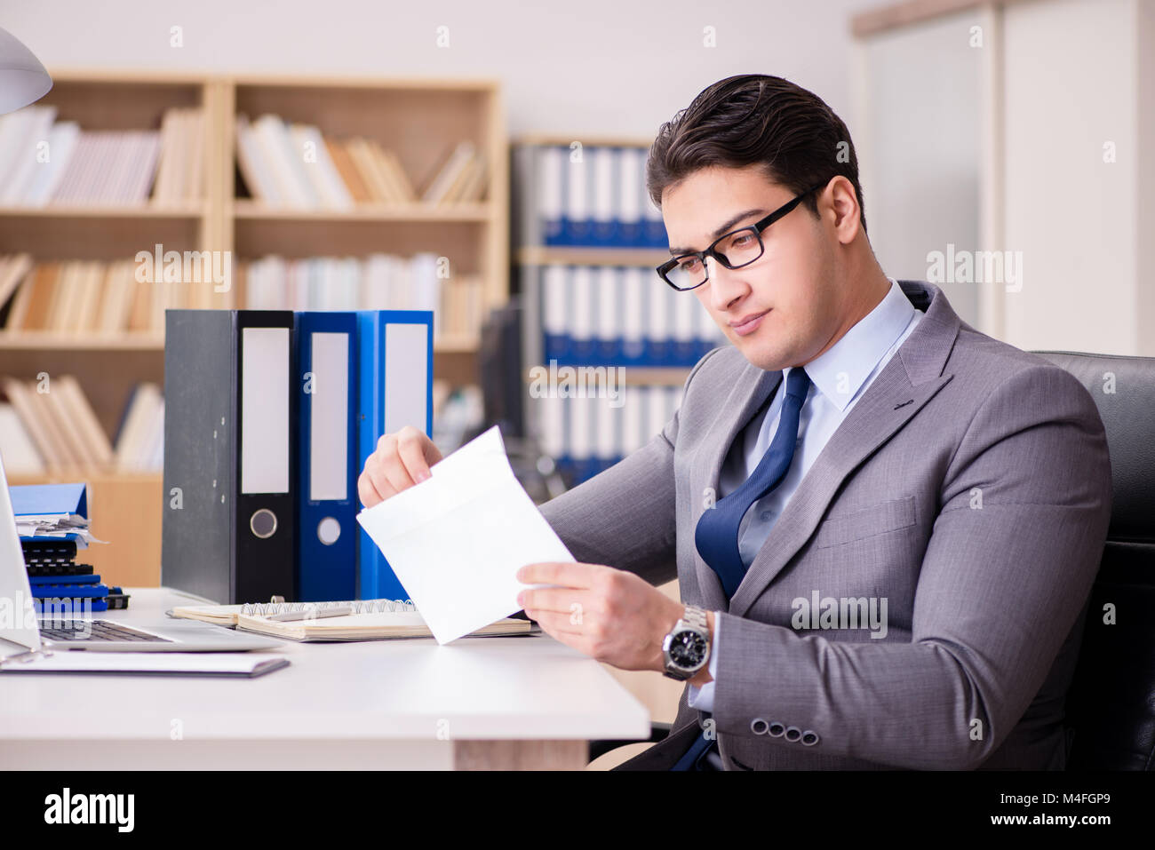 Businessman receiving letter in the office Stock Photo - Alamy