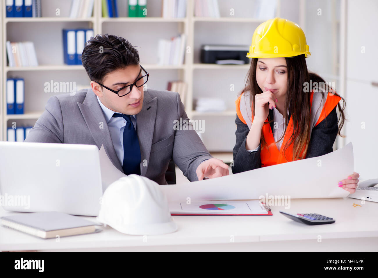 Reviewing architectural drawings hi-res stock photography and images ...