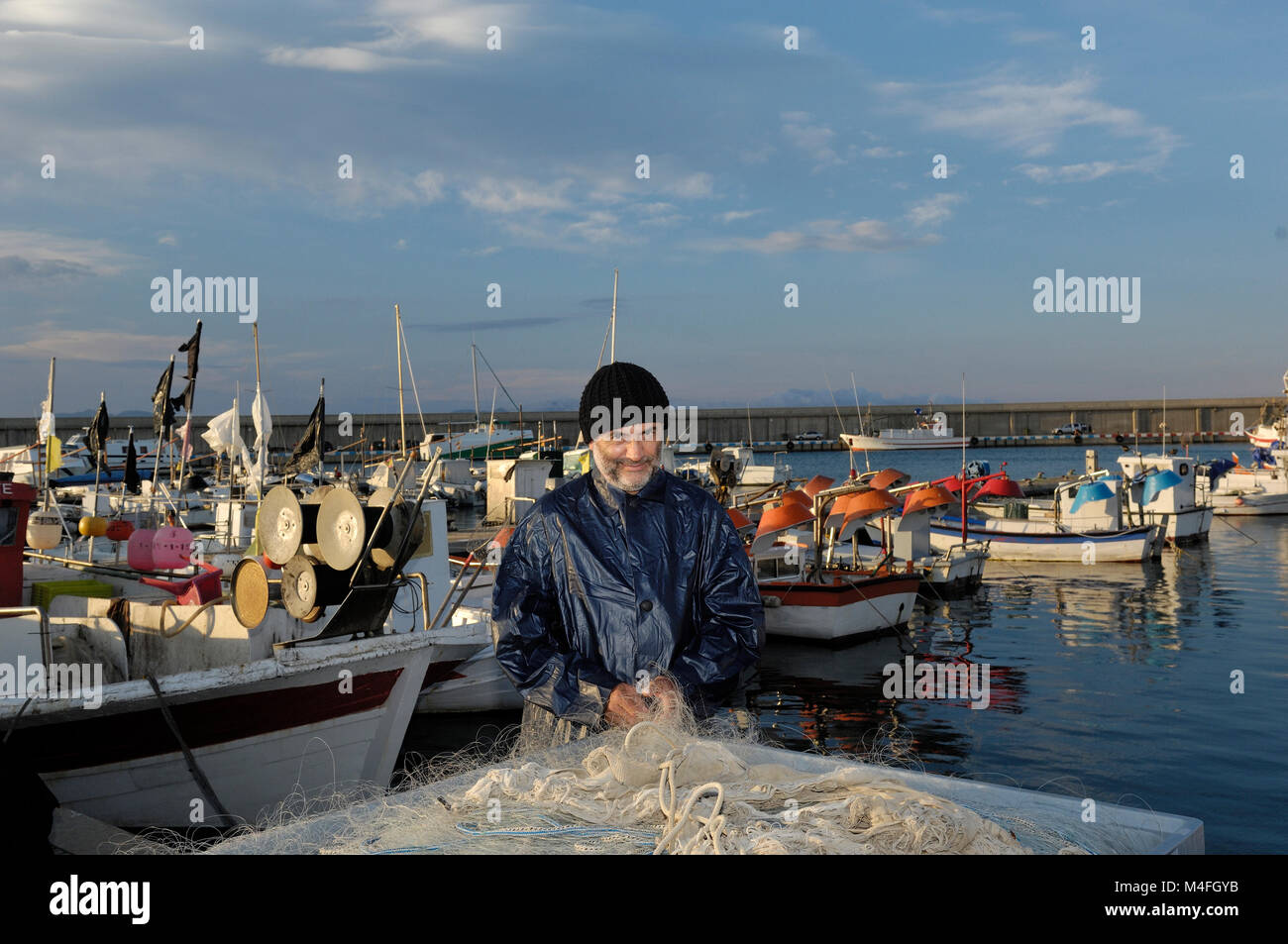 fisherman working in the fishing port Stock Photo - Alamy