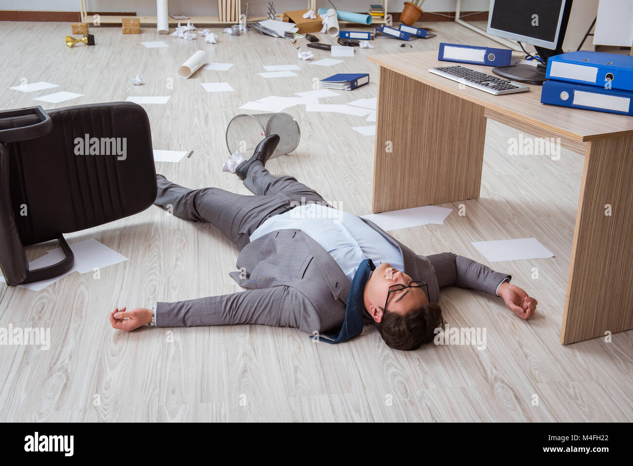 Businessman dead on the office floor Stock Photo - Alamy