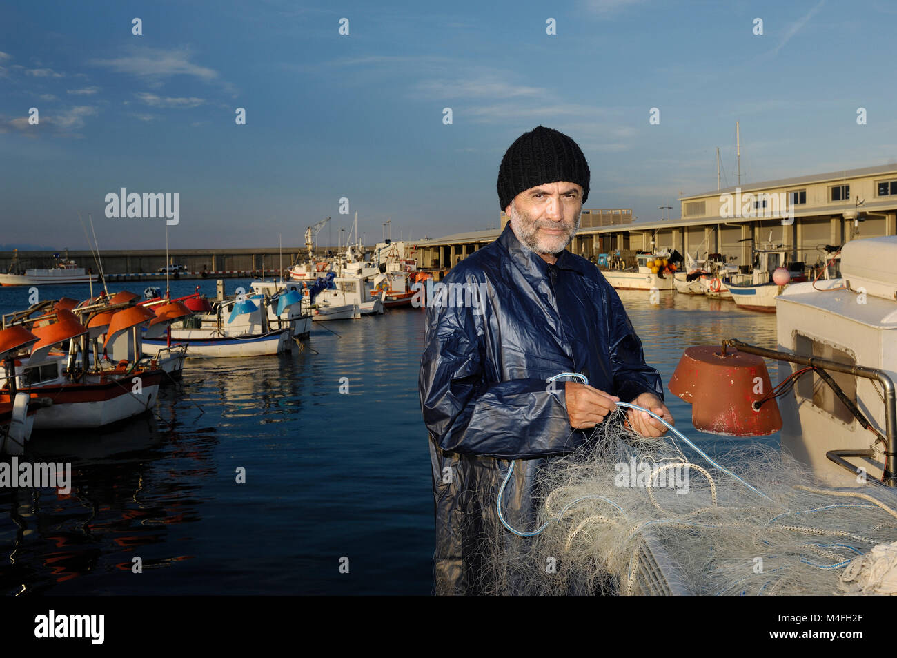 fisherman working in the fishing port Stock Photo - Alamy