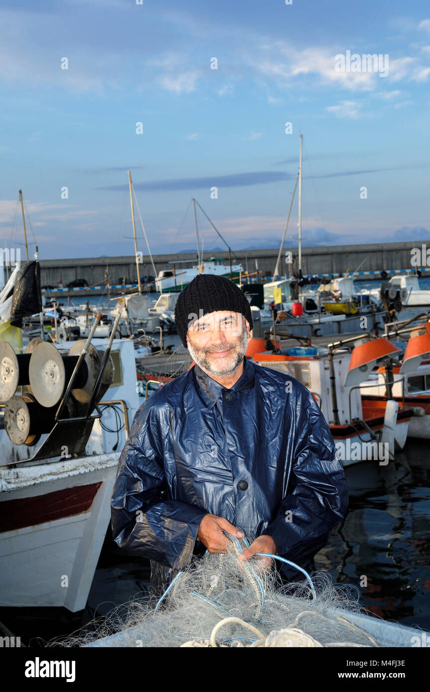 fisherman working in the fishing port Stock Photo - Alamy