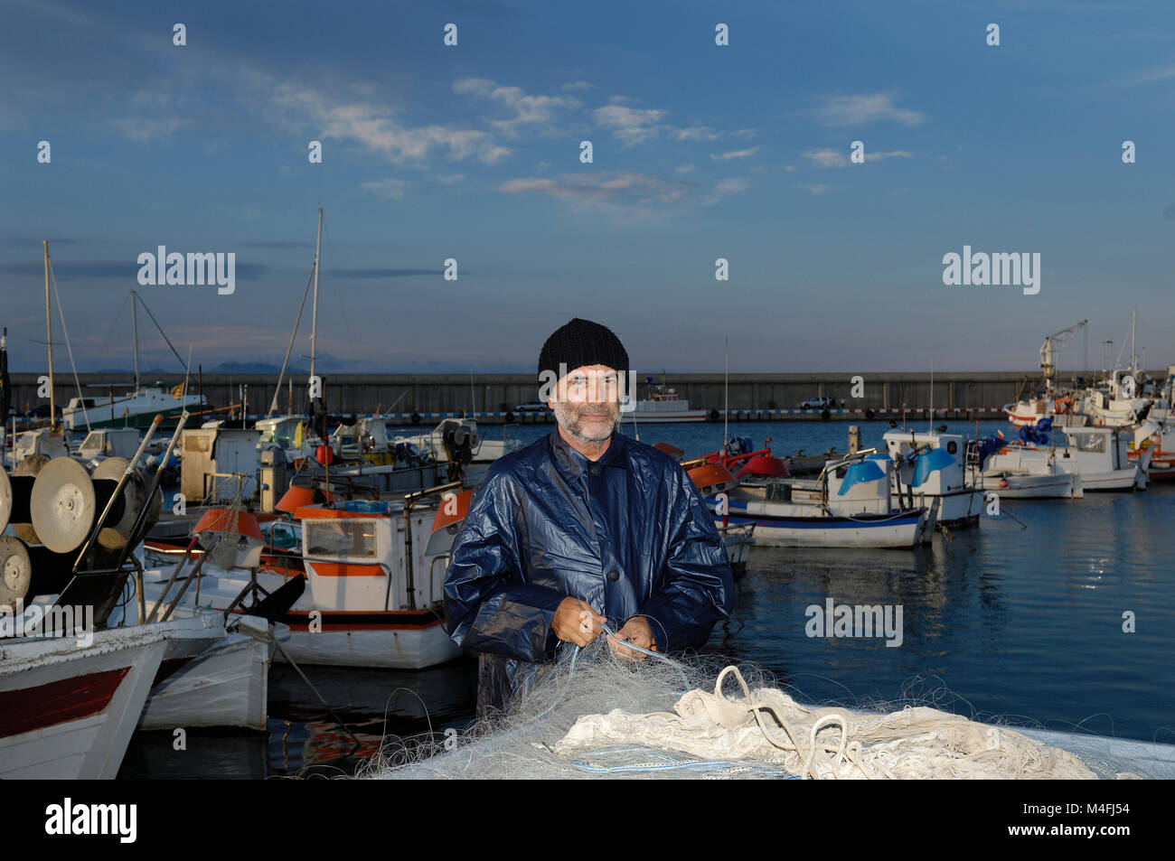 fisherman working in the fishing port Stock Photo - Alamy
