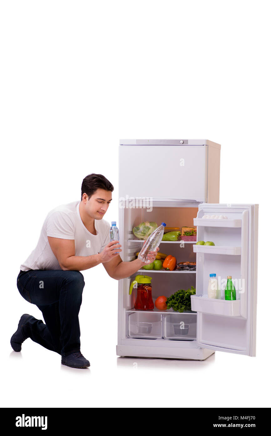 Man next to fridge full of food Stock Photo - Alamy