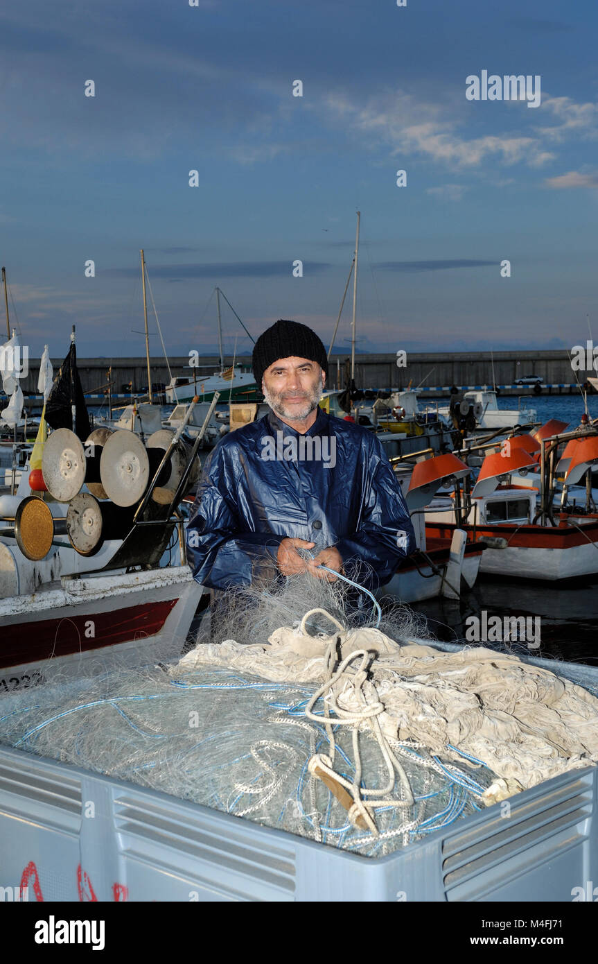 fisherman working in the fishing port Stock Photo - Alamy