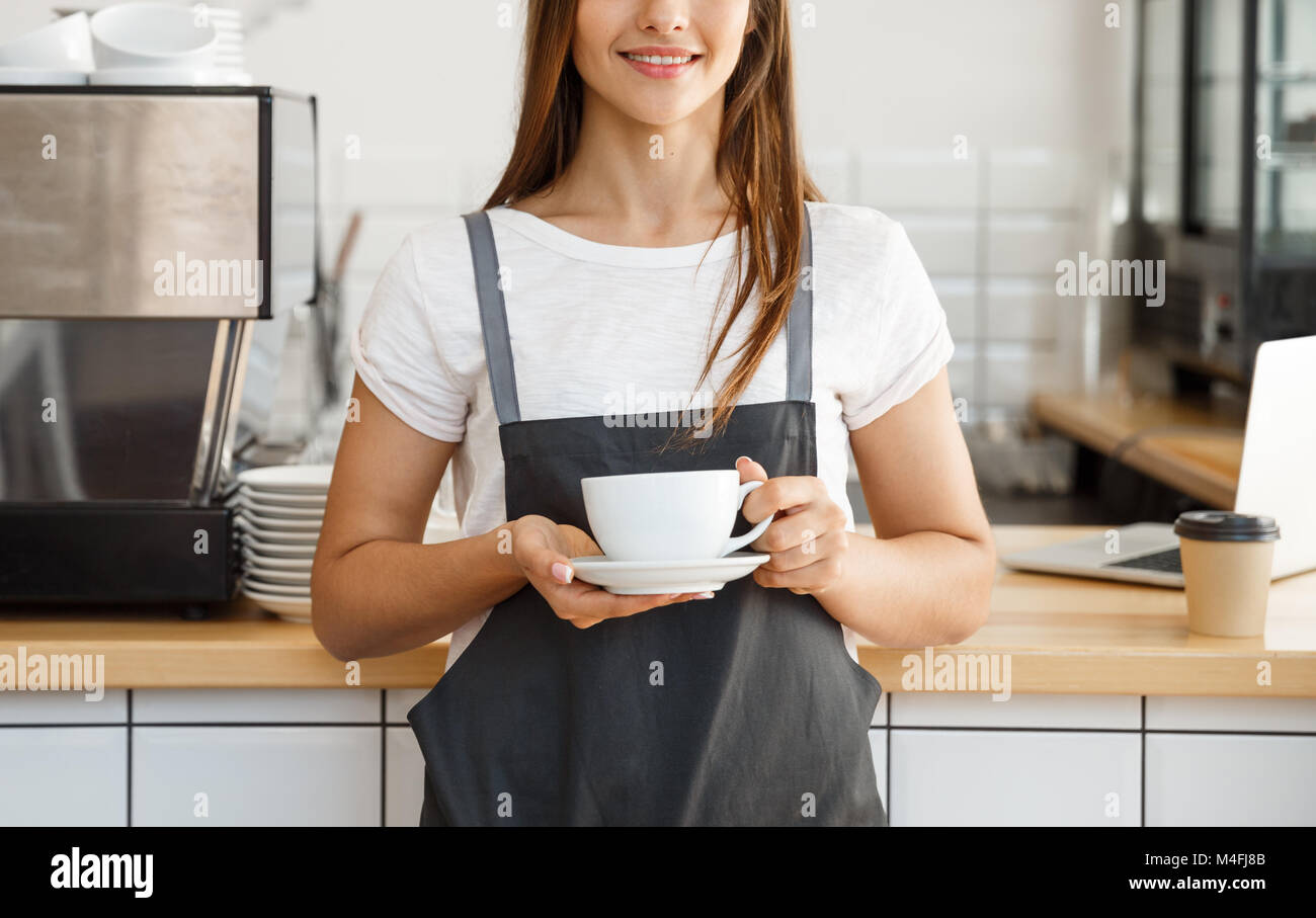 Coffee Business Concept - Caucasian female serving coffee while ...