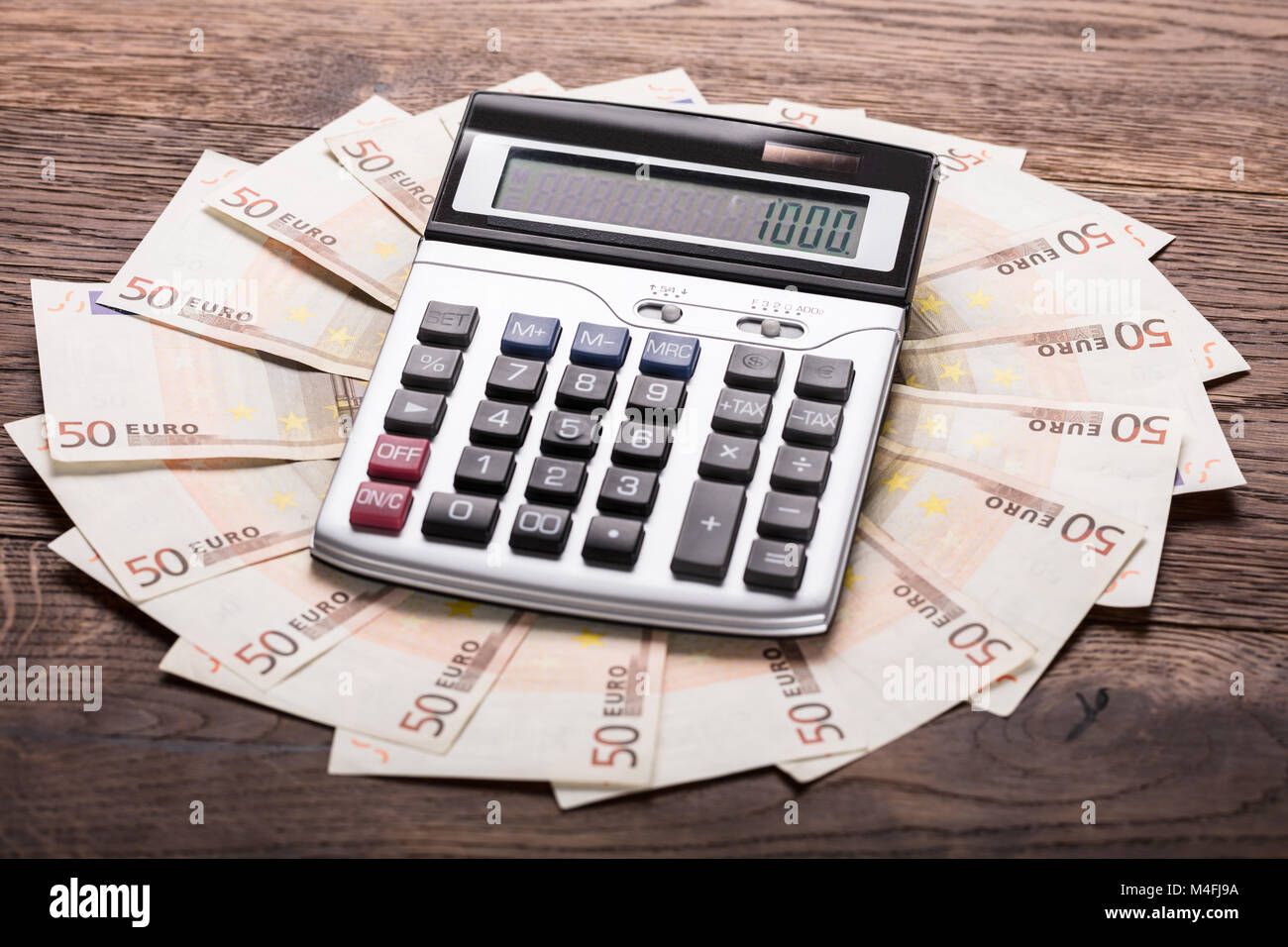 Calculator Showing Calculated Value On Euro Notes At Wooden Desk Stock ...