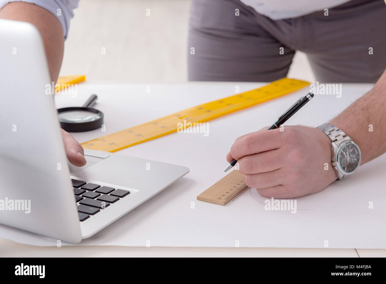 Male engineer working on drawings and blueprints Stock Photo - Alamy