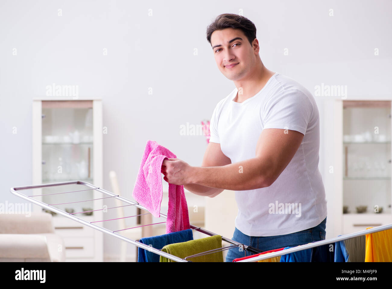 Man doing laundry at home Stock Photo - Alamy