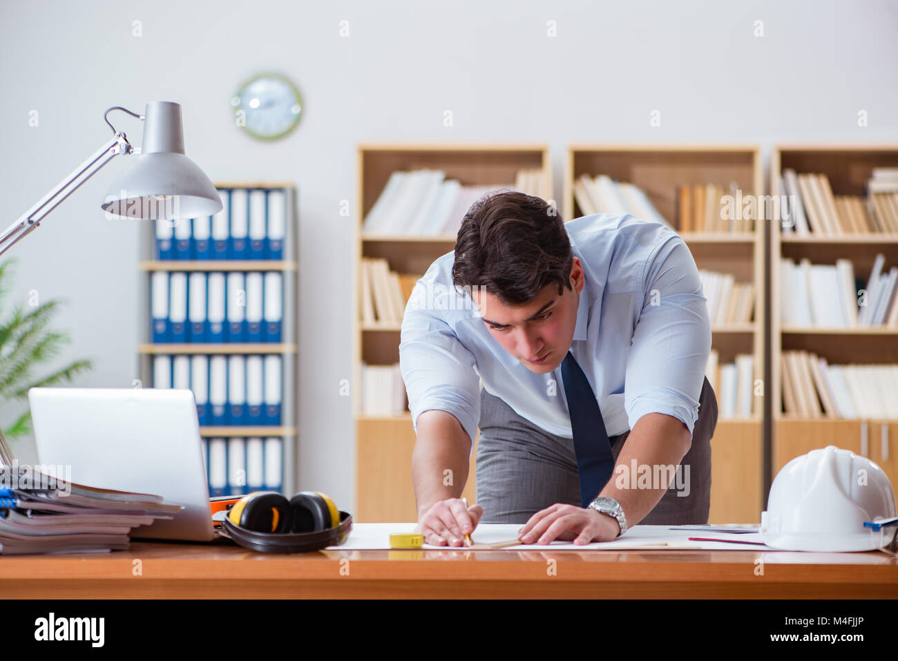 Engineer supervisor working on drawings in the office Stock Photo - Alamy