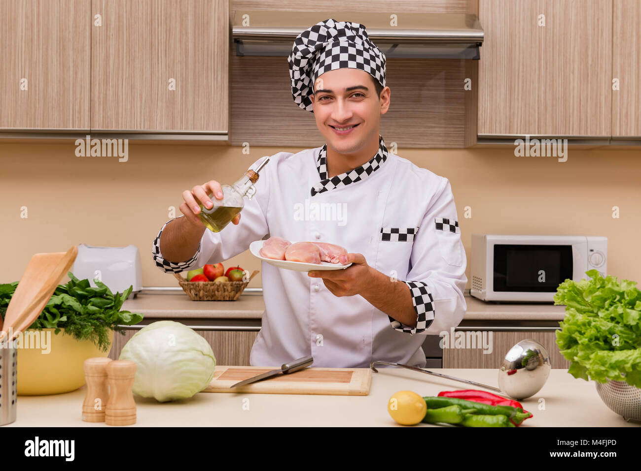 Young chef working in the kitchen Stock Photo - Alamy