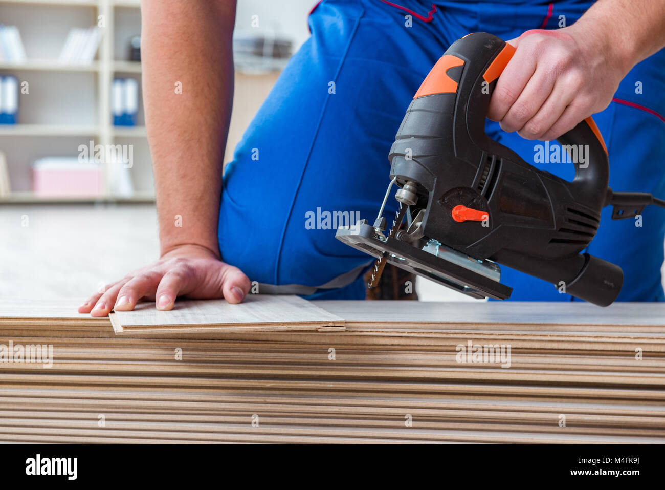 Young worker working on floor laminate tiles Stock Photo - Alamy