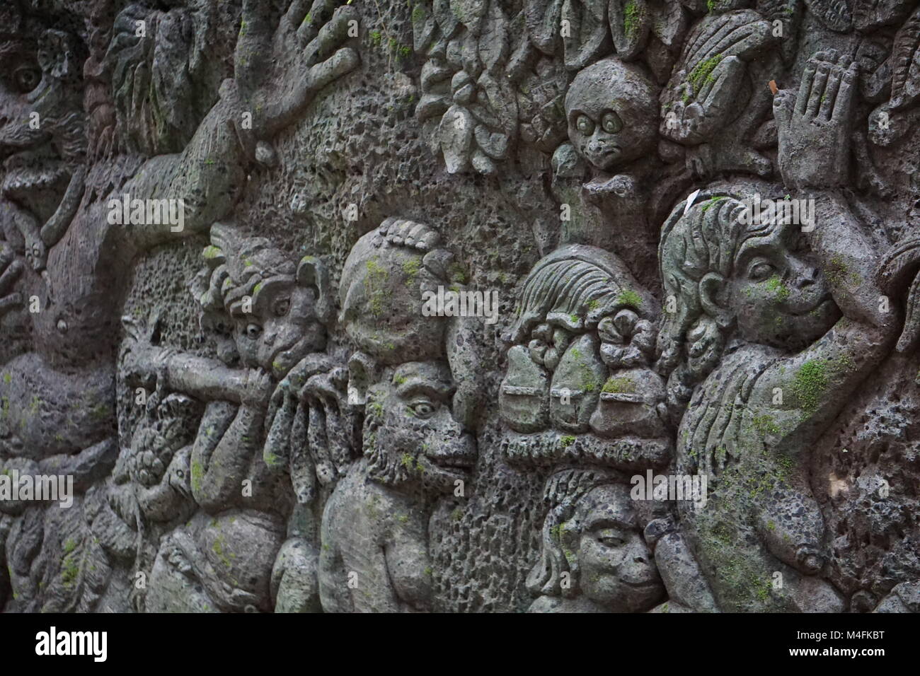 Wall with reliefs and moss in Bali Indonesia Stock Photo - Alamy
