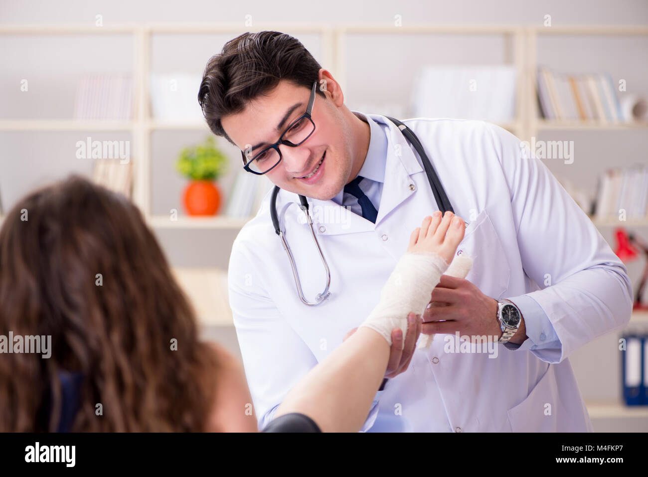 Traumatologist is taking care of the patient Stock Photo - Alamy