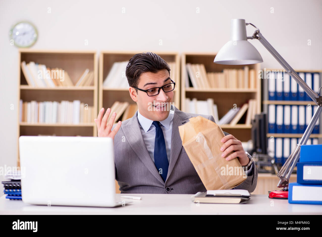 Businessman receiving parcel in the office Stock Photo - Alamy