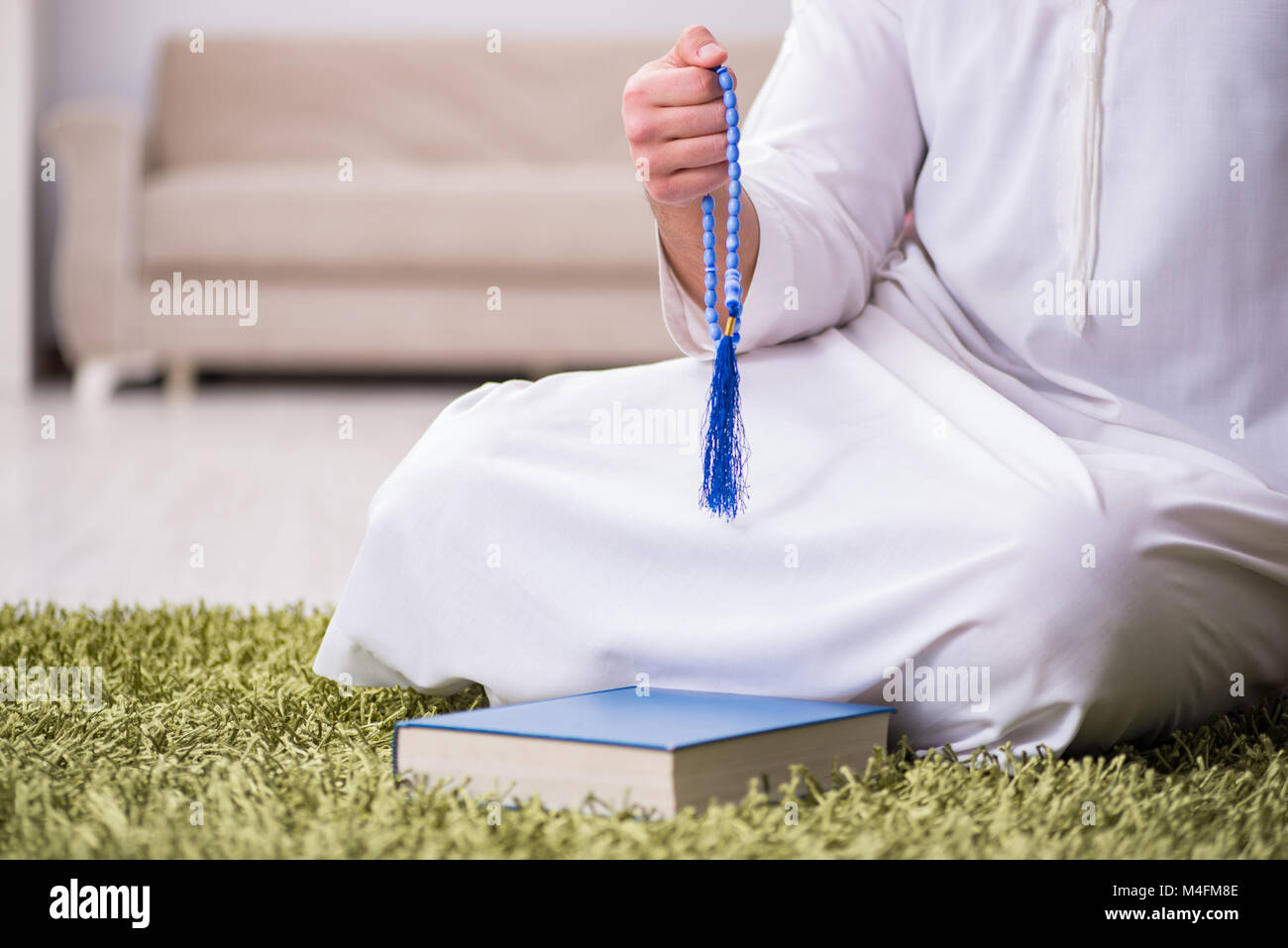 Arab man praying at home Stock Photo - Alamy