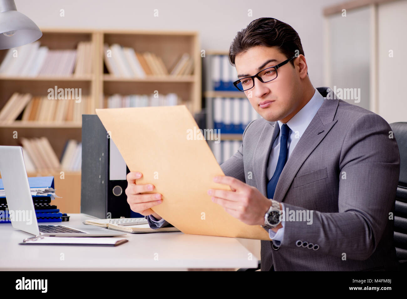 Businessman receiving letter envelope in office Stock Photo - Alamy
