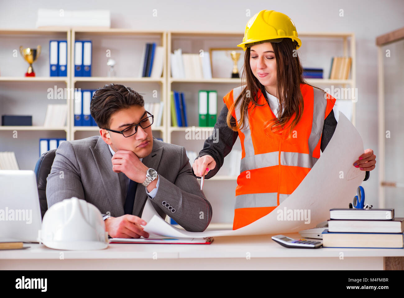 Construction foreman supervisor reviewing drawings Stock Photo - Alamy