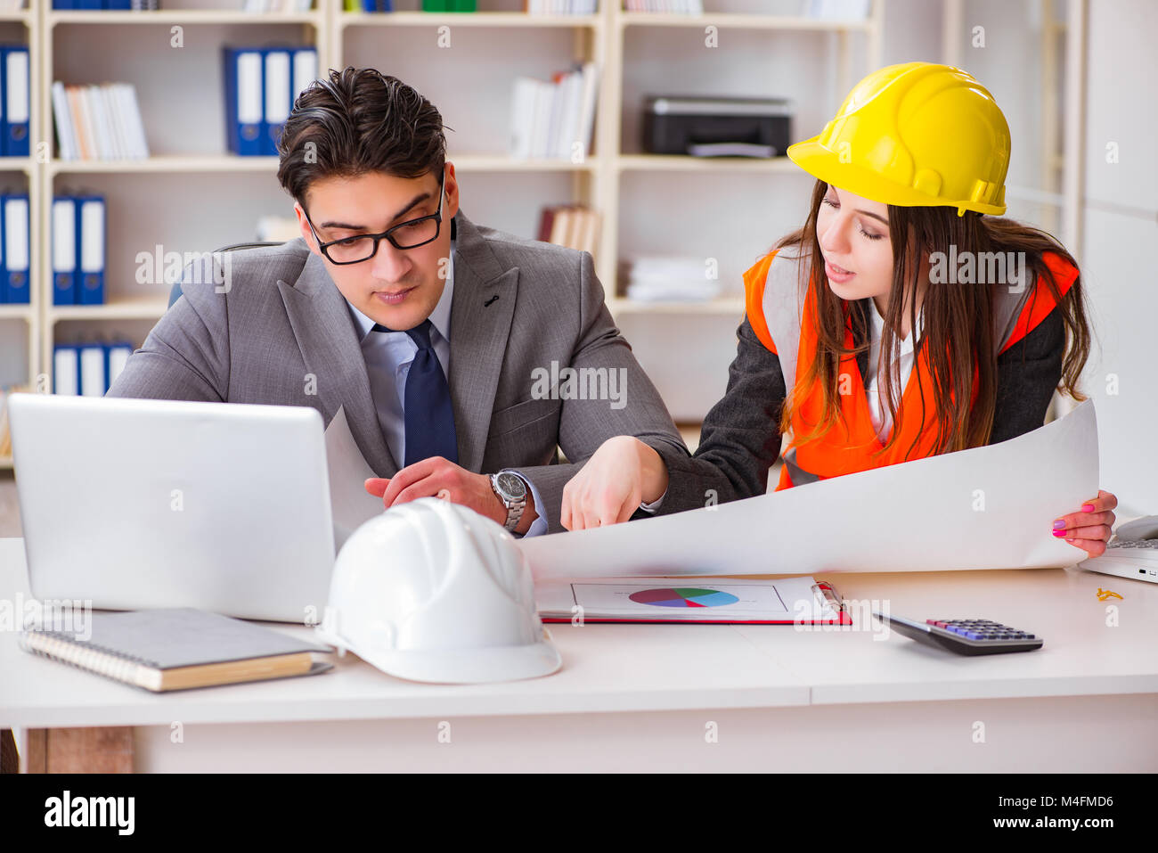 Reviewing architectural drawings hi-res stock photography and images ...