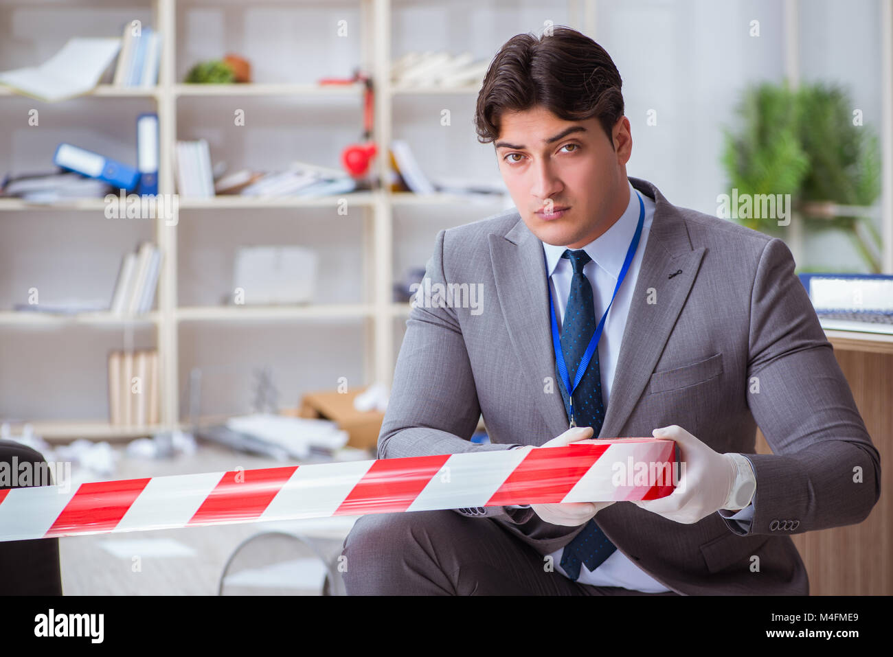 Young man during crime investigation in office Stock Photo - Alamy