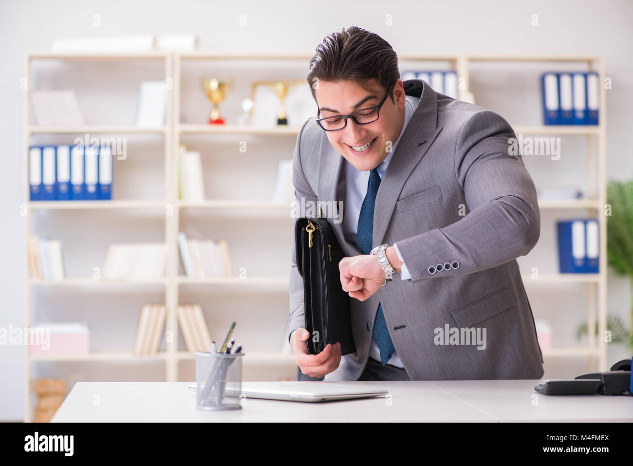 Businessman rushing in the office Stock Photo - Alamy