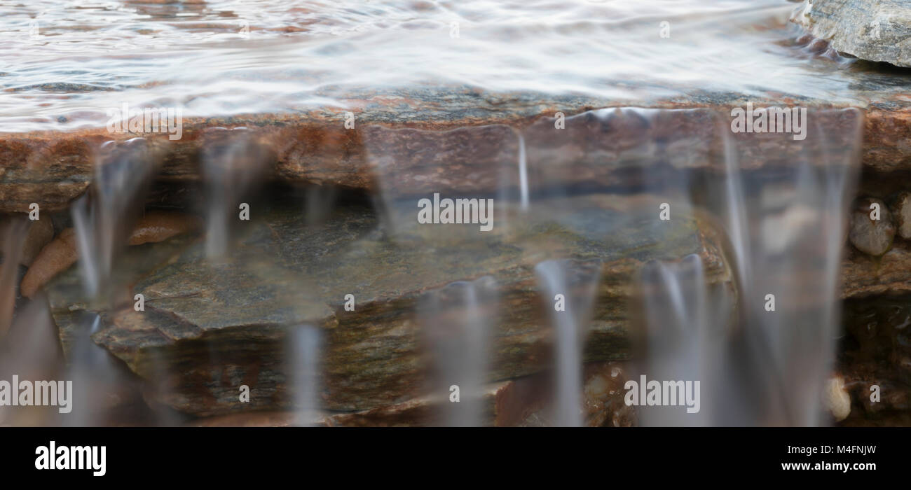 Waterfall with rock and stone with water flowing over top Stock Photo ...